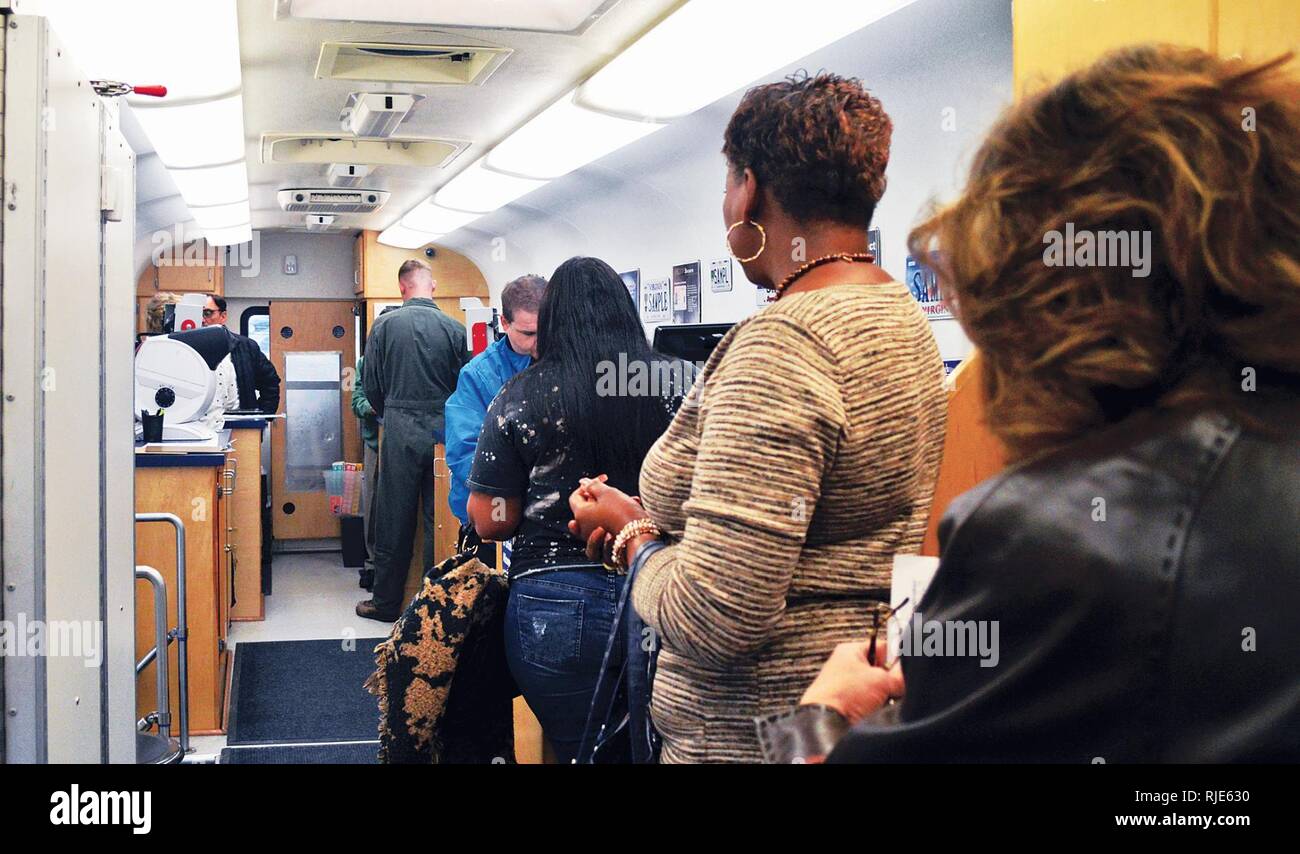 Patrons of Marine Corps Base Quantico line up inside the DMV 2 Go van ...