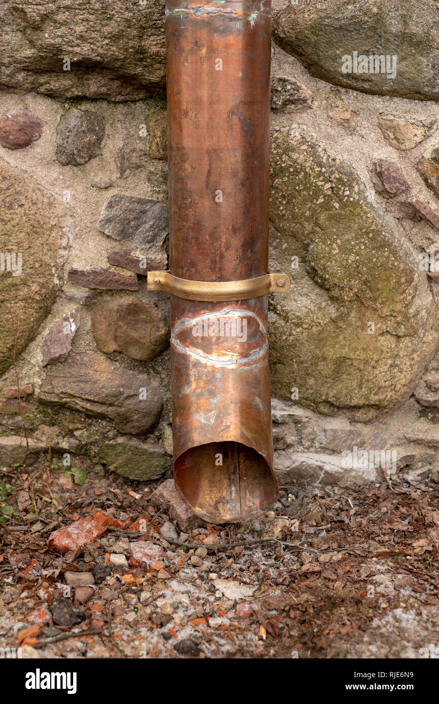 Old copper drain gutter in a brick building. Installation that drains ...