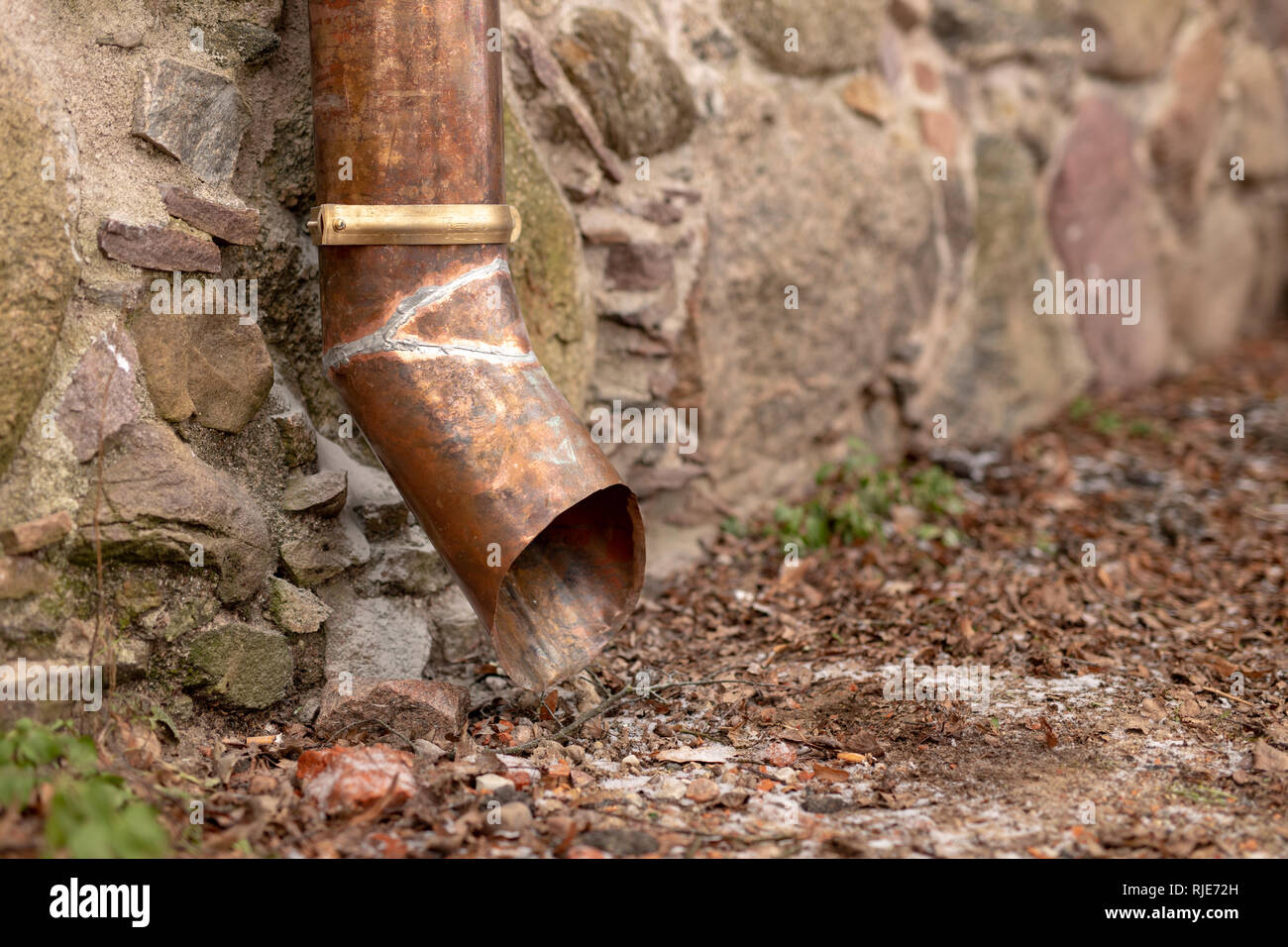 Old copper drain gutter in a brick building. Installation that drains ...