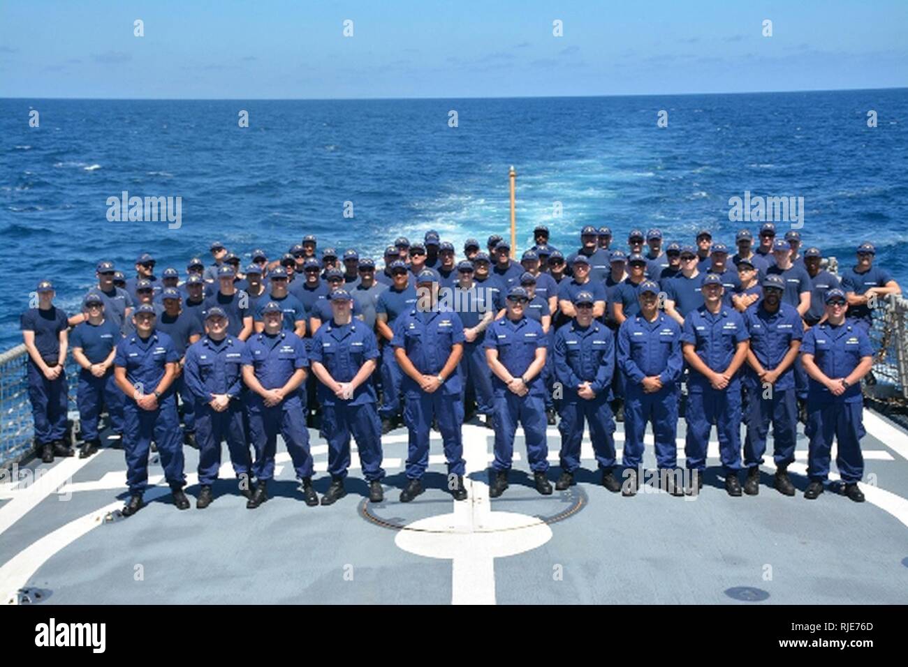 The crew of Coast Guard Cutter Diligence poses for a group photo aboard ...