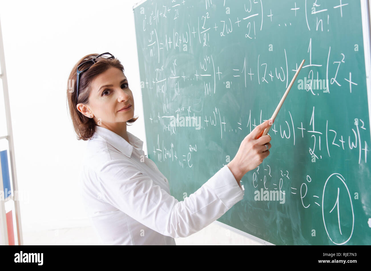 Female math teacher in front of the chalkboard Stock Photo - Alamy