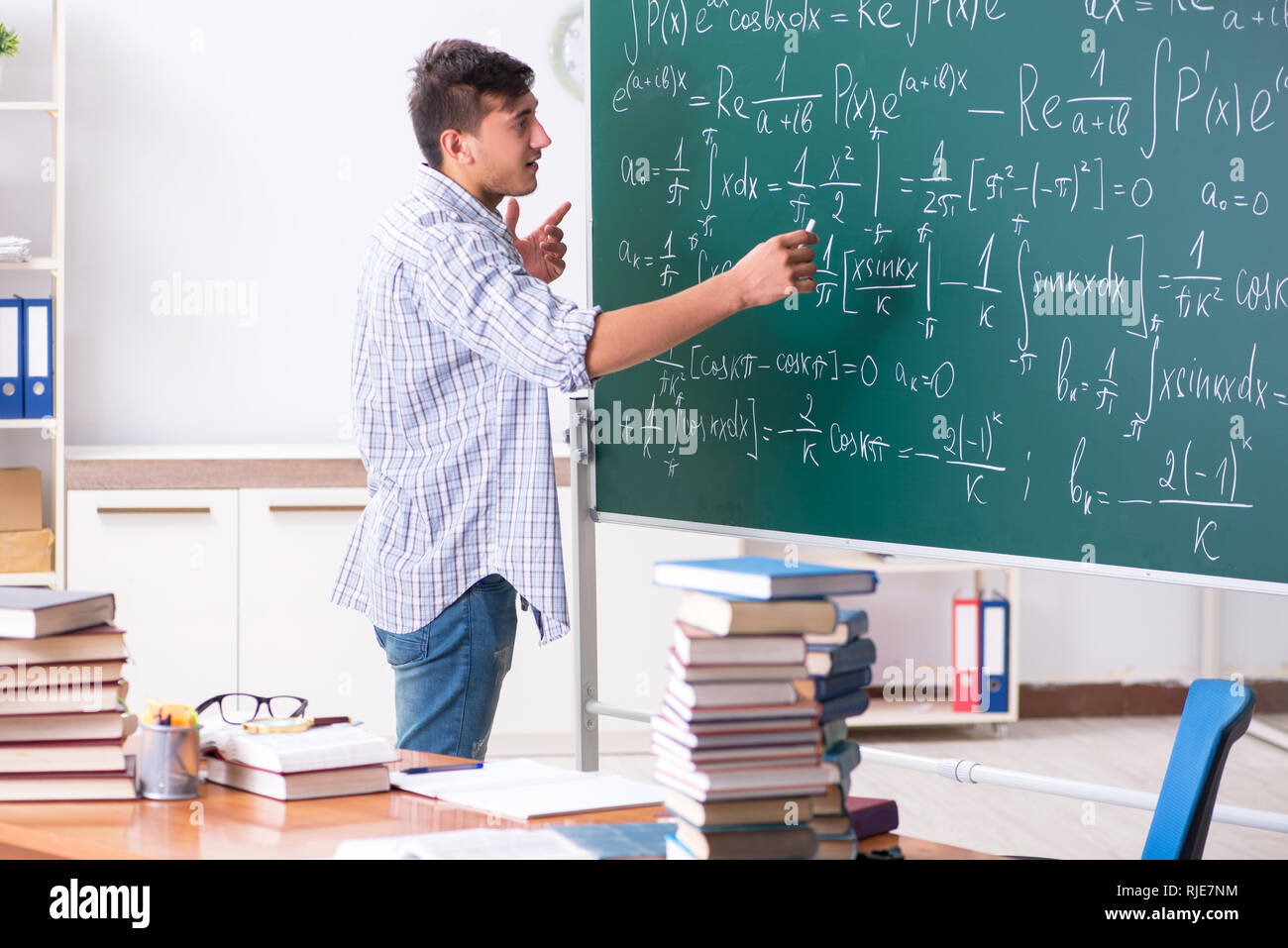 Young male student studying math at school Stock Photo - Alamy