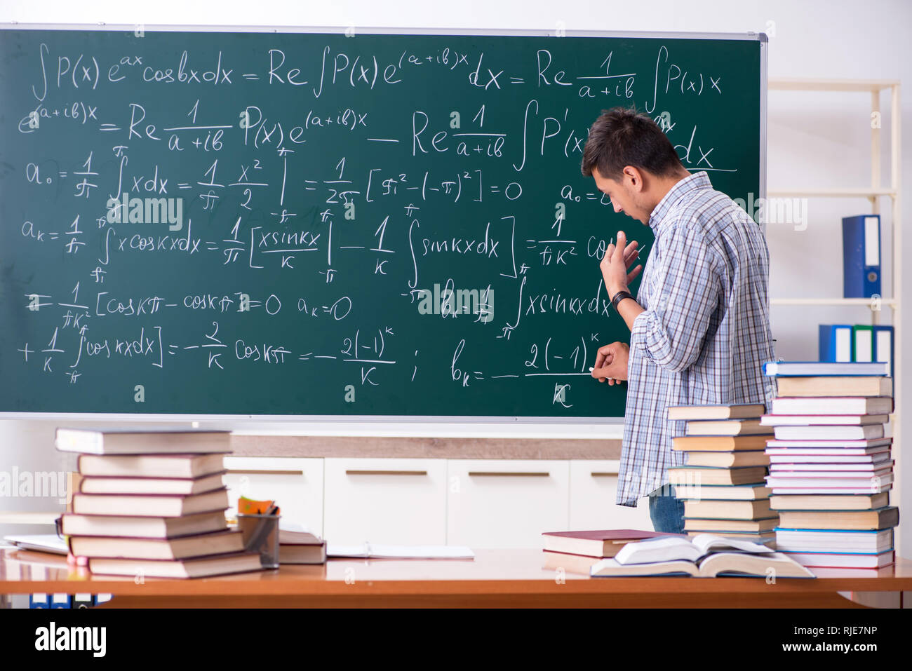 Young male student studying math at school Stock Photo - Alamy