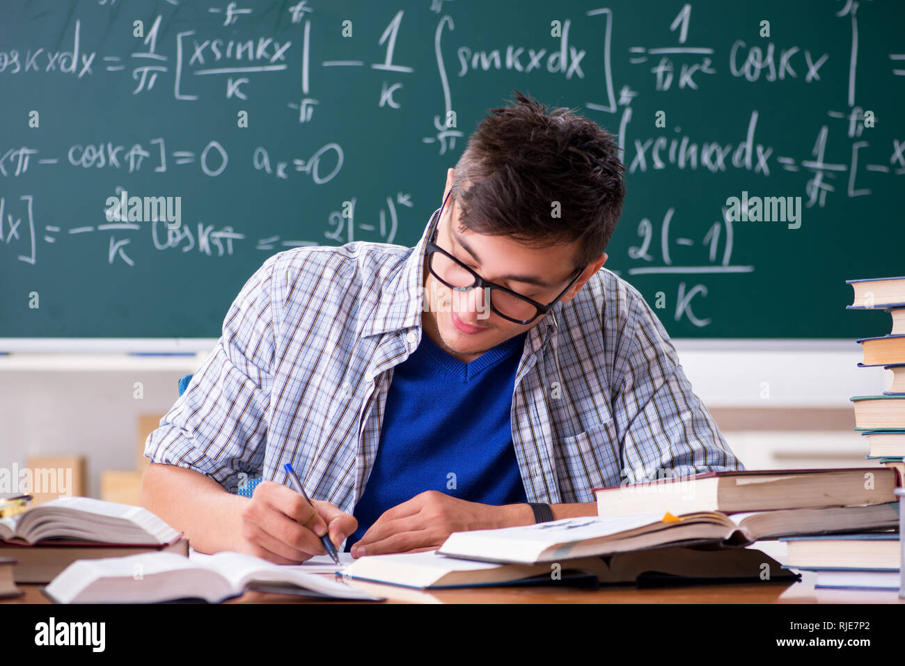 Young male student studying math at school Stock Photo - Alamy