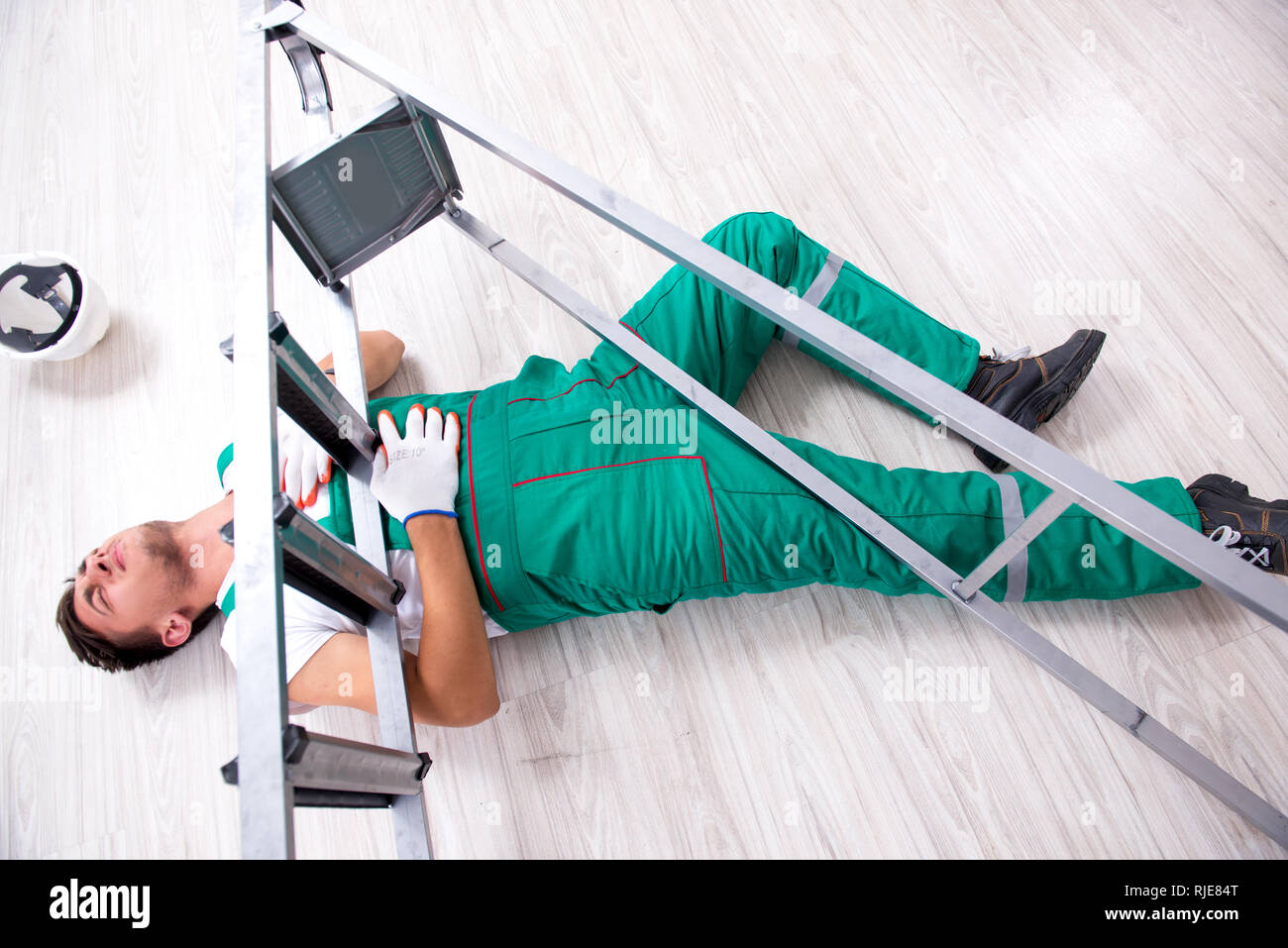 Young worker falling from the ladder Stock Photo - Alamy