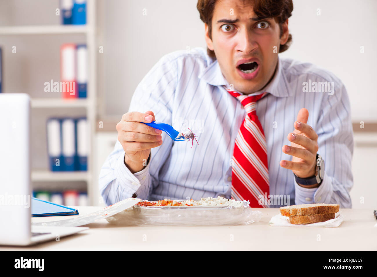 Employee eating food with cockroaches crawling around Stock Photo - Alamy