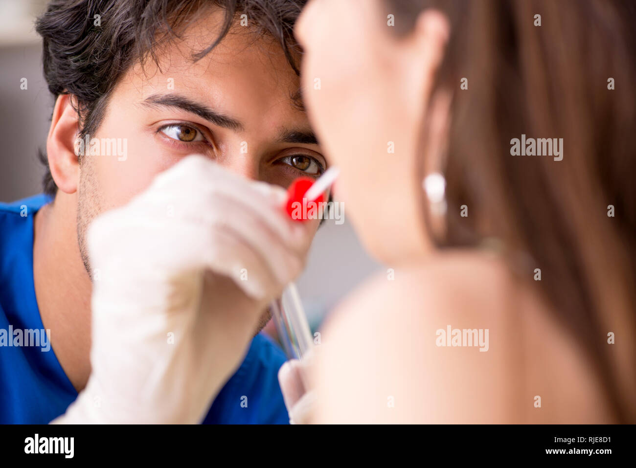 Doctor getting saliva test sample in clinic hospital Stock Photo - Alamy