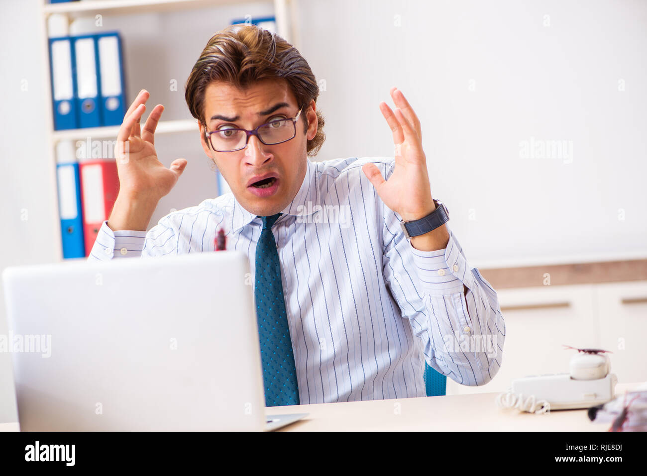 Businessman disgusted with cockroaches in the office Stock Photo - Alamy