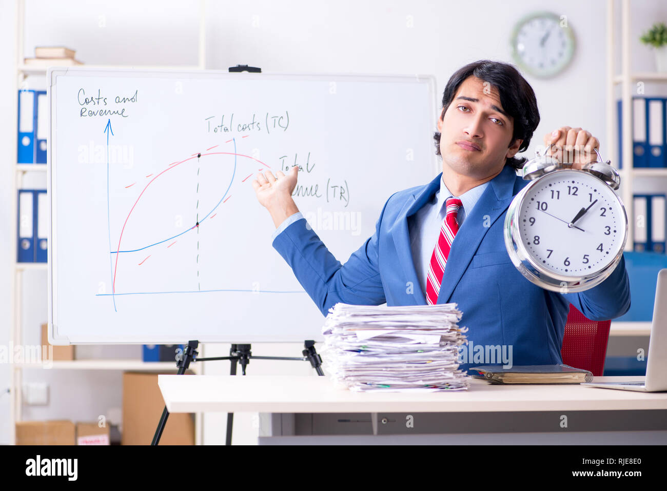 Busy businessman explaining business charts Stock Photo - Alamy