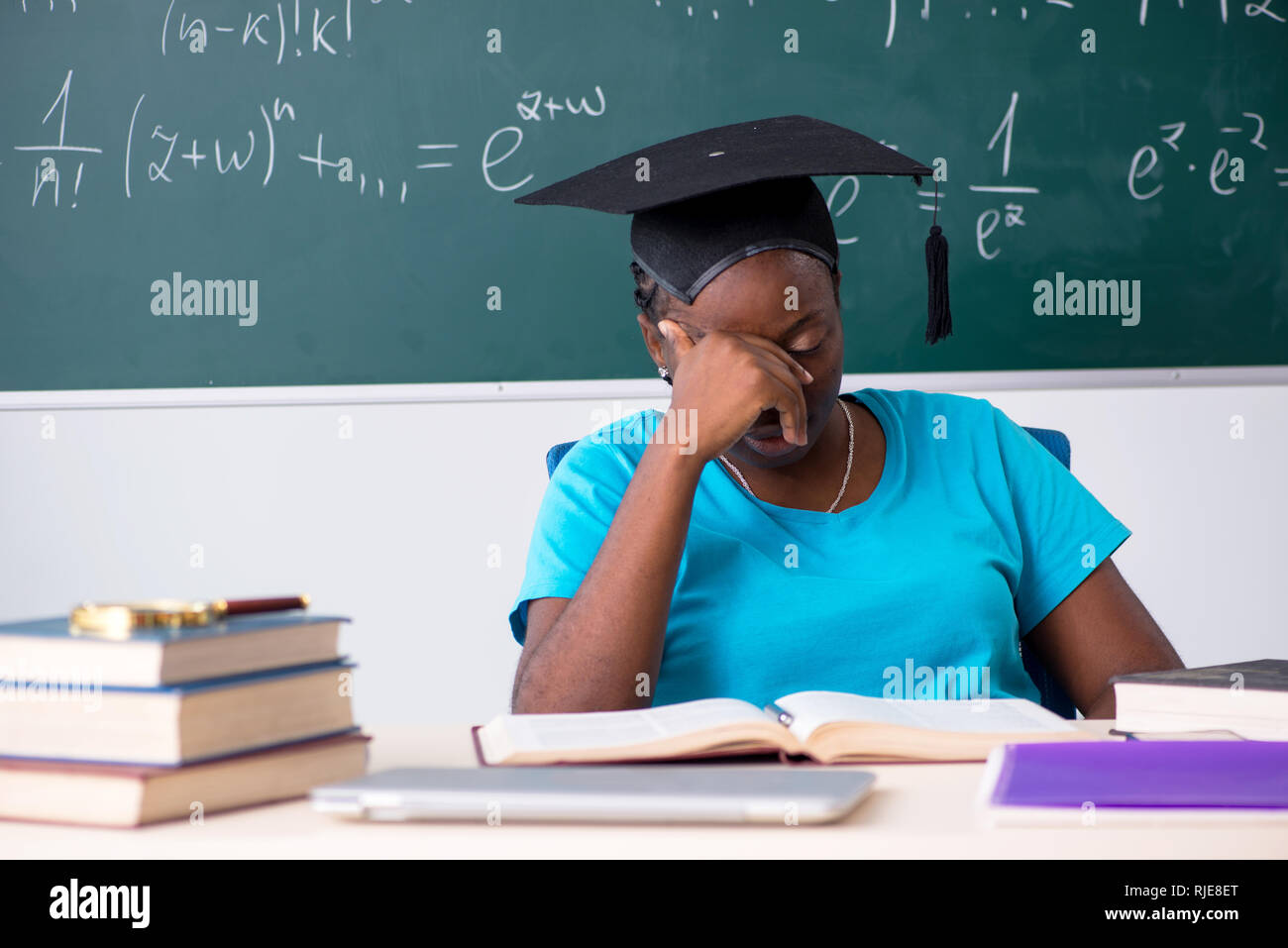 Black female student in front of chalkboard Stock Photo - Alamy