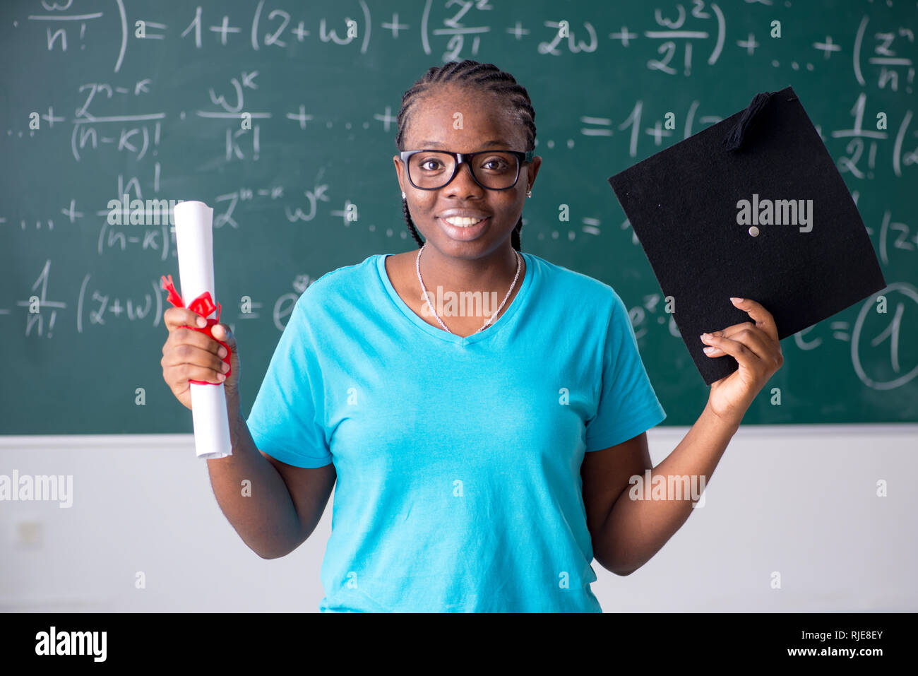 Black female student in front of chalkboard Stock Photo - Alamy