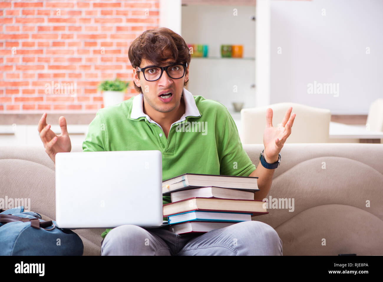 Teenager revising laptop books at home hi-res stock photography and ...