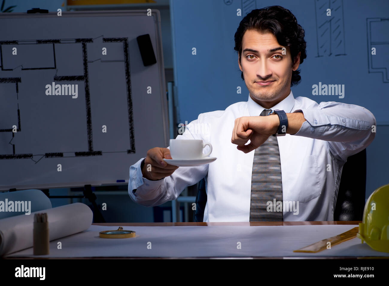 Young construction architect working on project at night Stock Photo ...