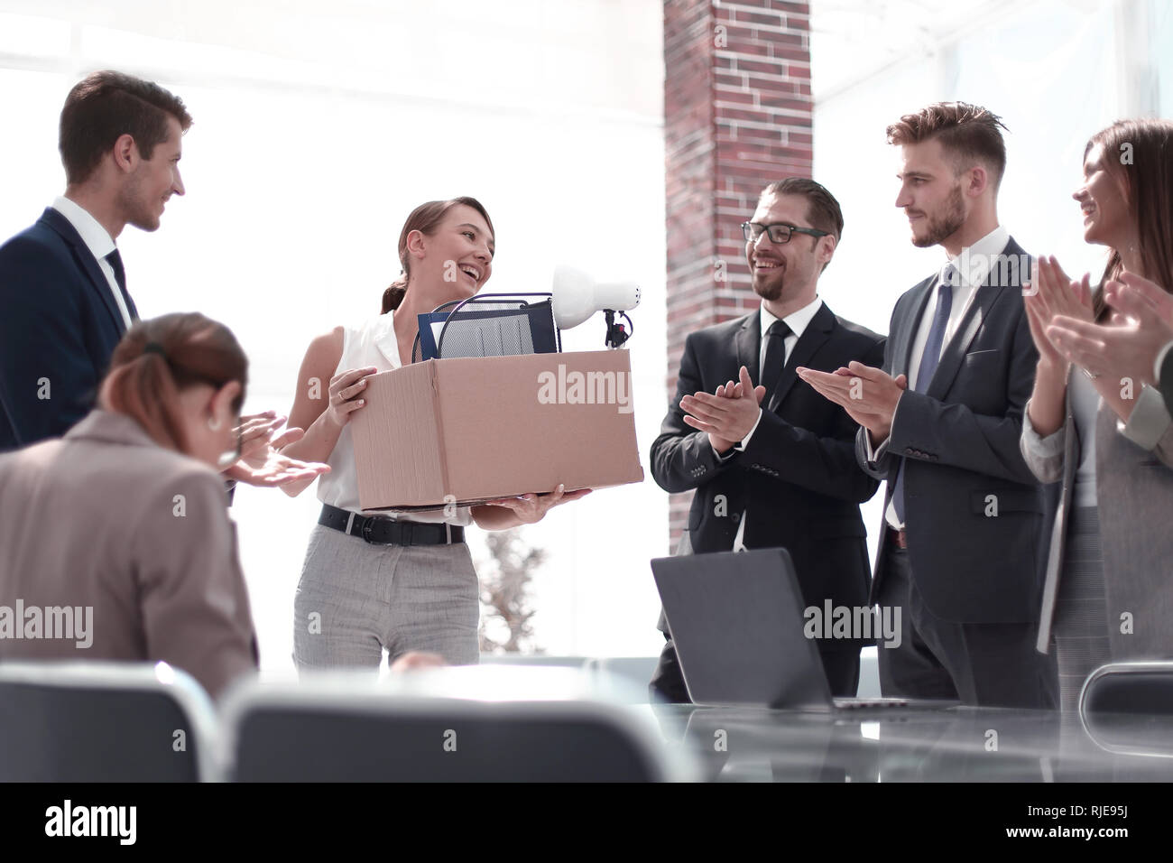 business team congratulating colleague on promotion Stock Photo - Alamy