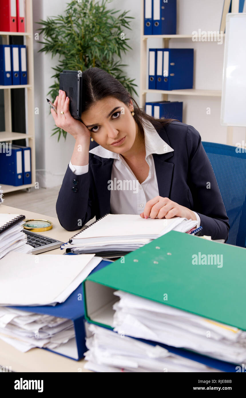 Female employee with too much work in the office Stock Photo - Alamy