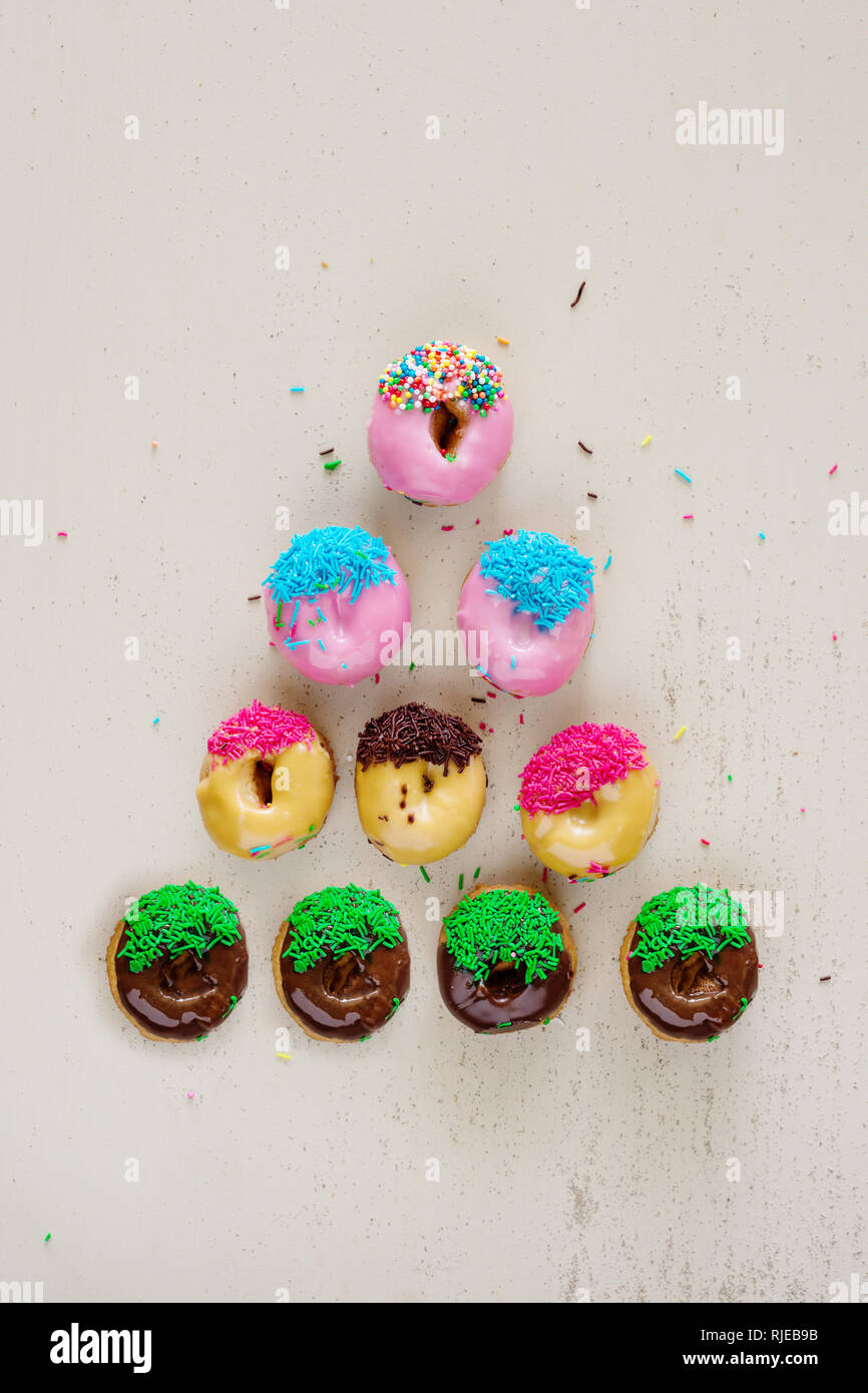 mini donuts in various colours on a plain background Stock Photo - Alamy