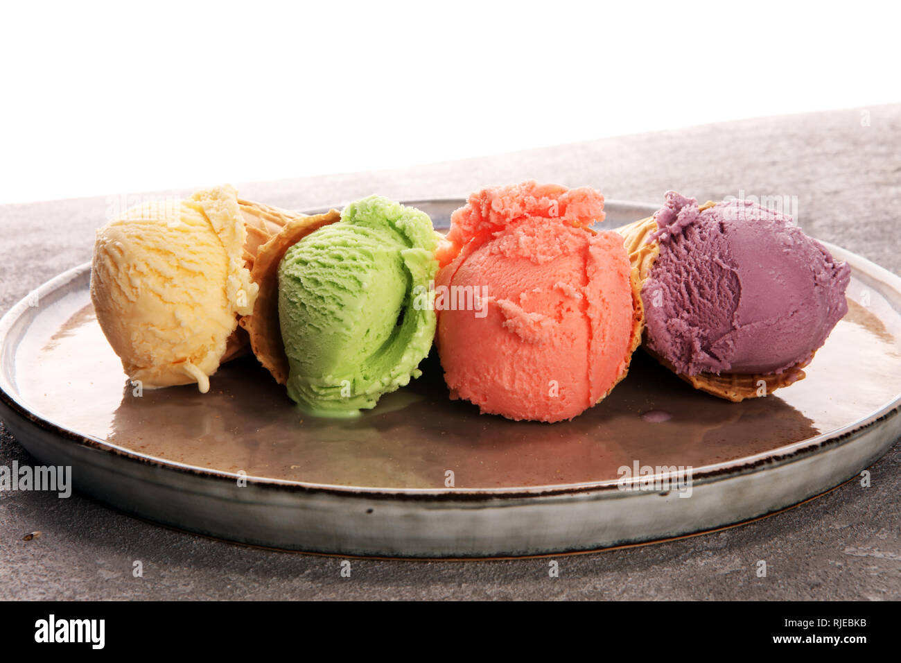 Set of ice cream scoops of different colors and flavours with berries ...