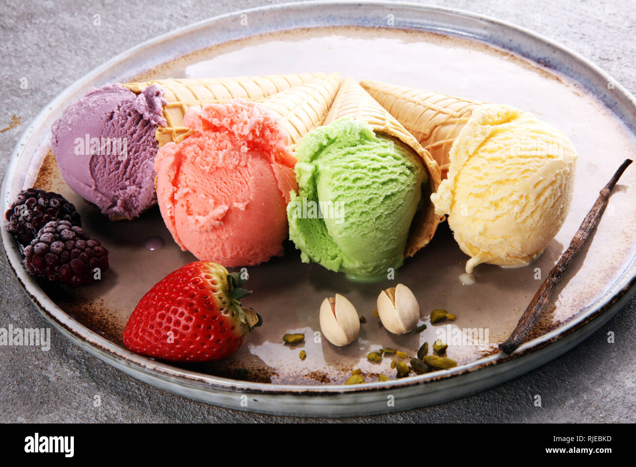 Set of ice cream scoops of different colors and flavours with berries ...