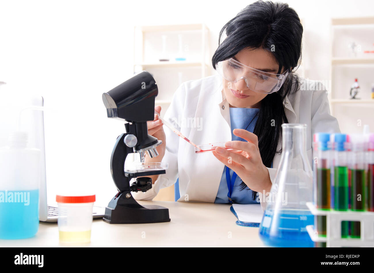 Female scientist mixing chemical solution hi-res stock photography and ...