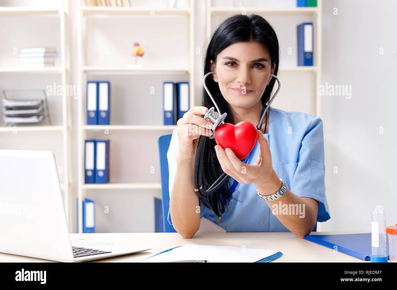 Female doctor cardiologist working in the clinic Stock Photo - Alamy