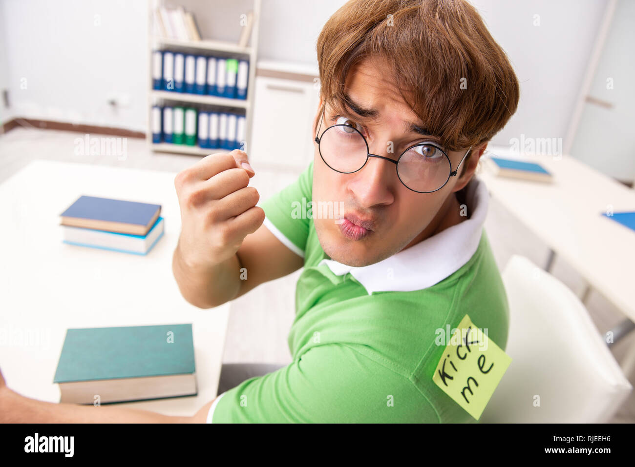 Office prank with kick me message on sticky note Stock Photo - Alamy