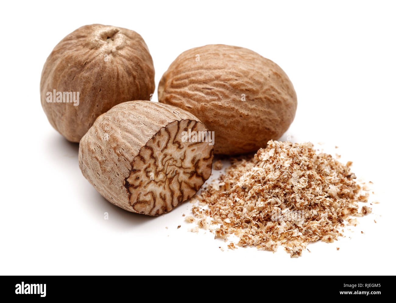 Whole and grated nutmeg isolated on white background Stock Photo - Alamy