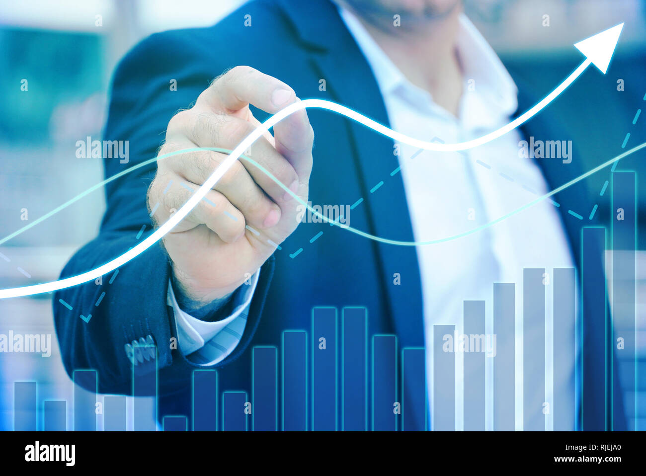 Businessman 's hand control trendline and volume chart Stock Photo - Alamy