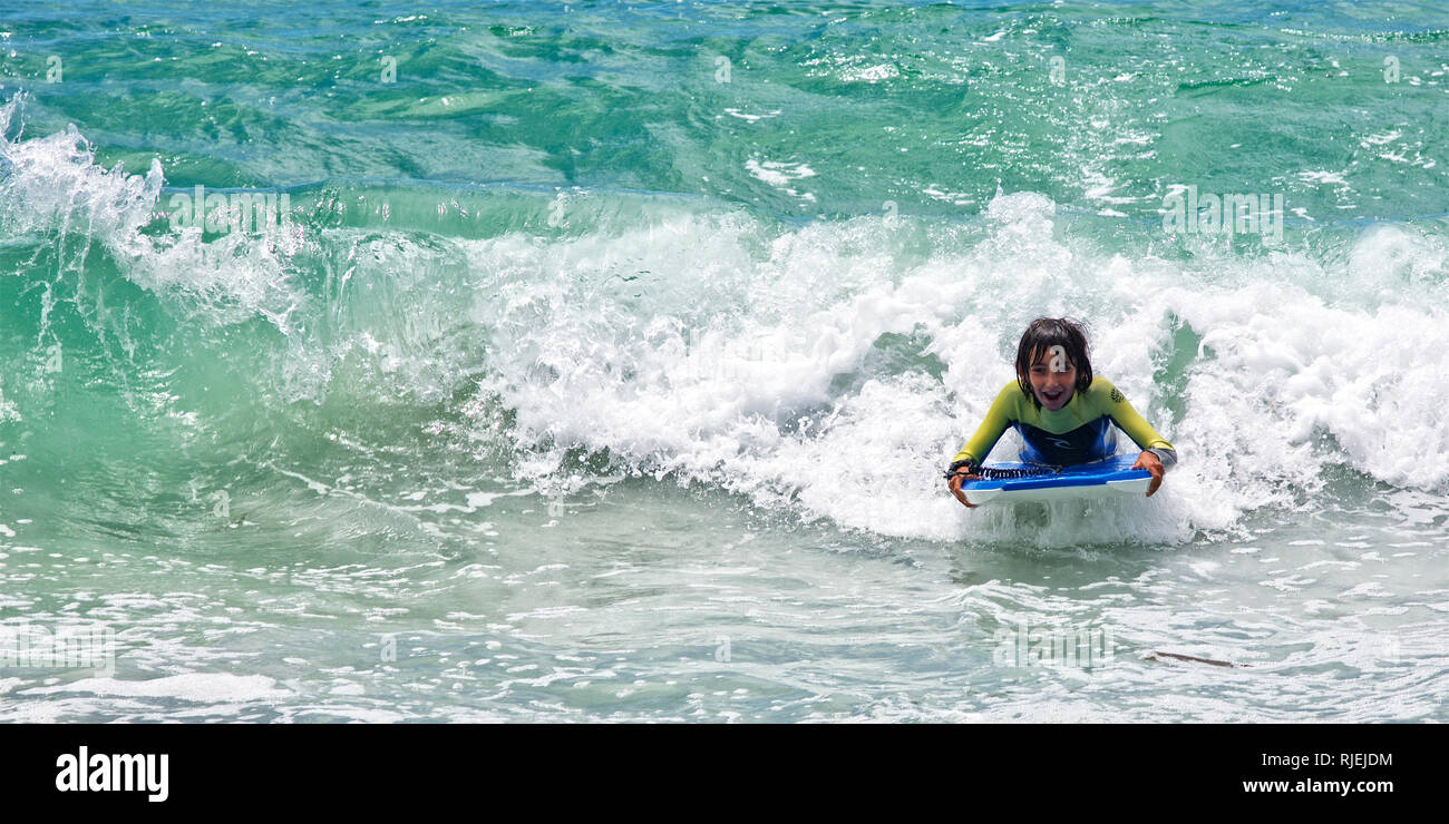 Boy boogie boarding at ocean hi-res stock photography and images - Alamy