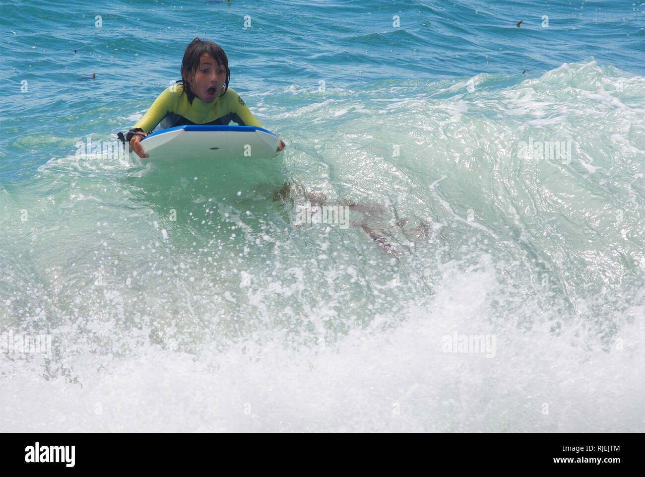 Boy boogie boarding at ocean hi-res stock photography and images - Alamy