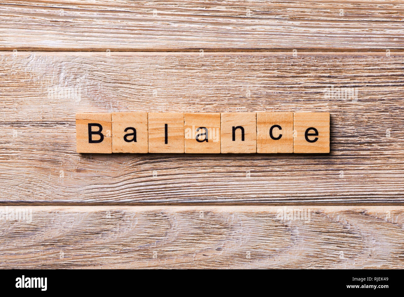 balance word written on wood block. balance text on wooden table for ...