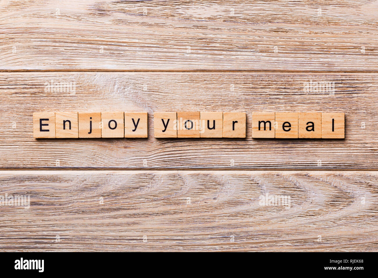 Enjoy your meal word written on wood block. Enjoy your meal text on ...