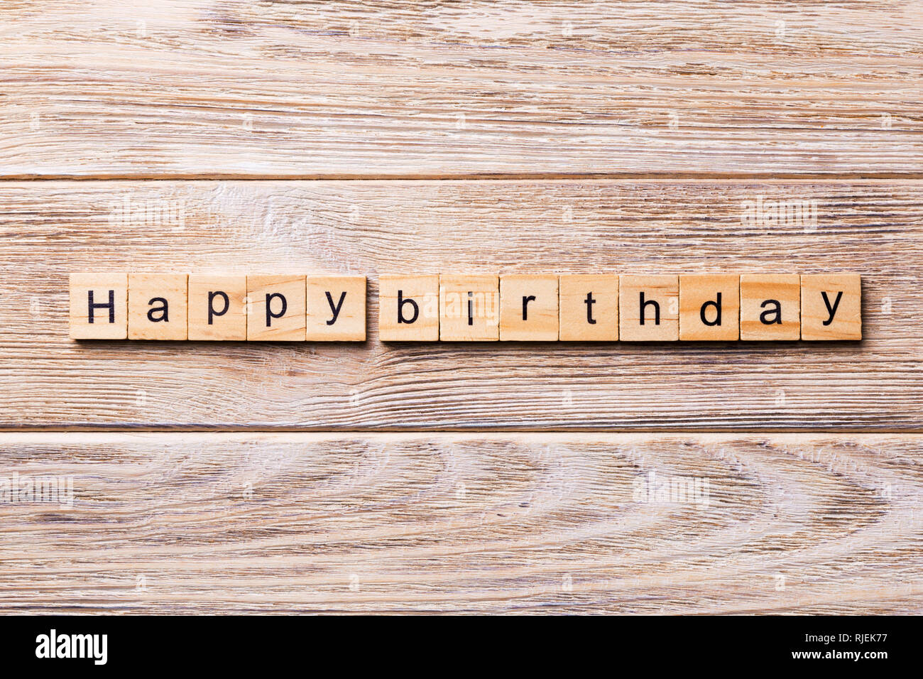 Happy Birthday word written on wood block. Happy Birthday text on ...