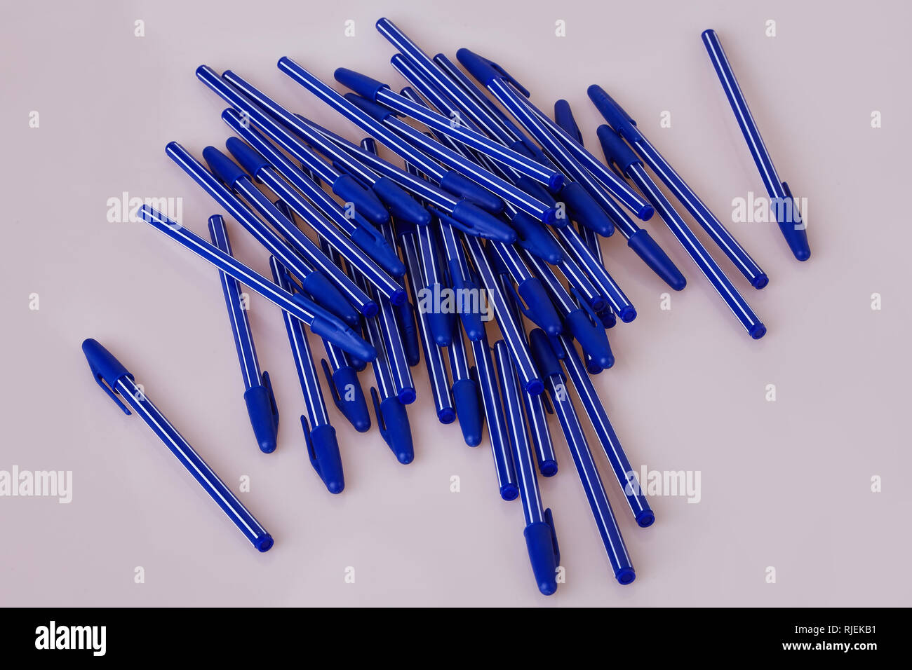Blue plastic pens isolated on white Stock Photo - Alamy