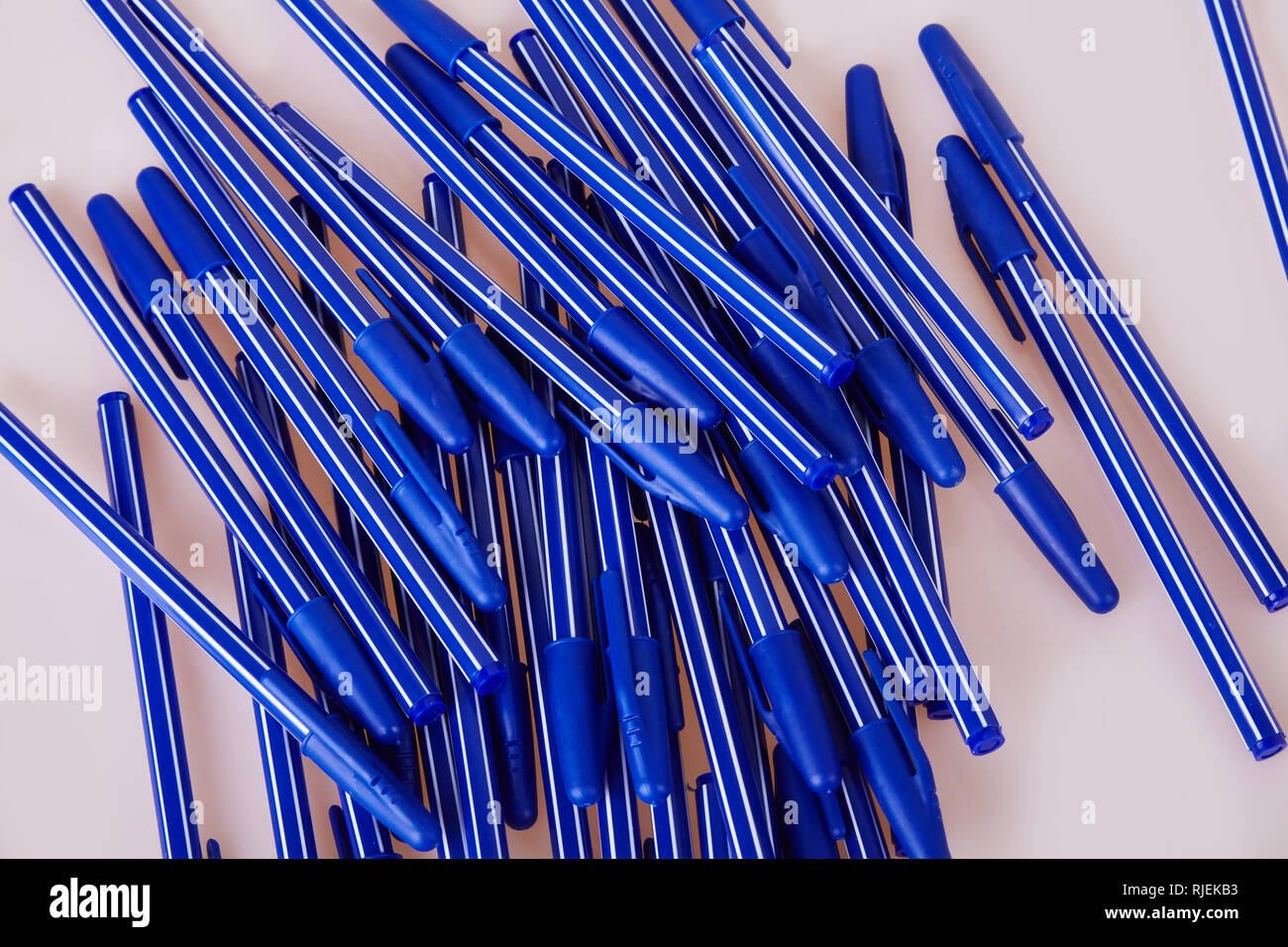 Blue plastic pens isolated on white Stock Photo - Alamy