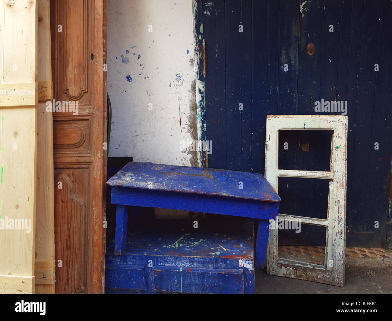 Old white wooden window frame, old wooden table, junk ejection against ...