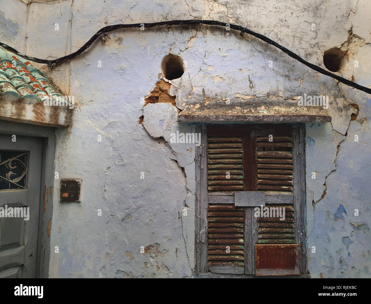 Windows with old frames on an ancient stone wall, Asila, Morocco ...
