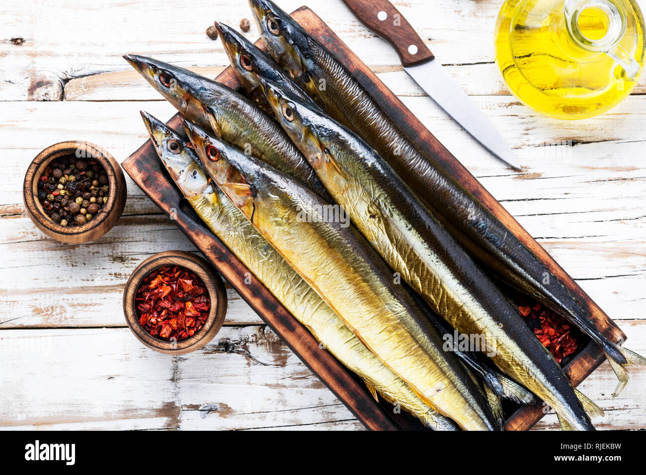 Smoked fish on kitchen board.Smoked saury.Fish food Stock Photo - Alamy