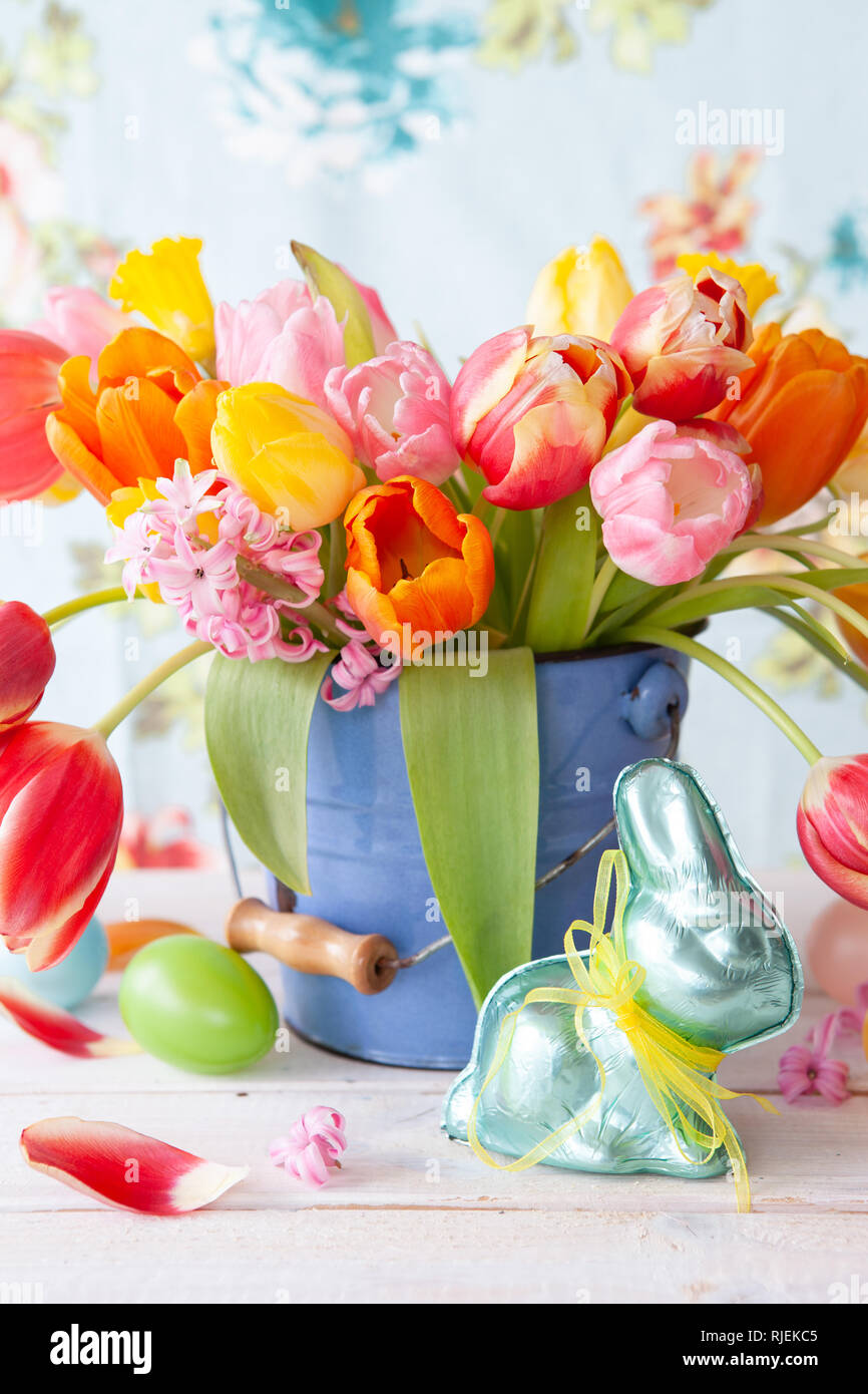 Colorful spring flowers in a little vintage bucket Stock Photo - Alamy