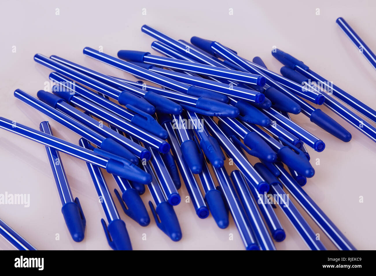 Blue plastic pens isolated on white Stock Photo - Alamy
