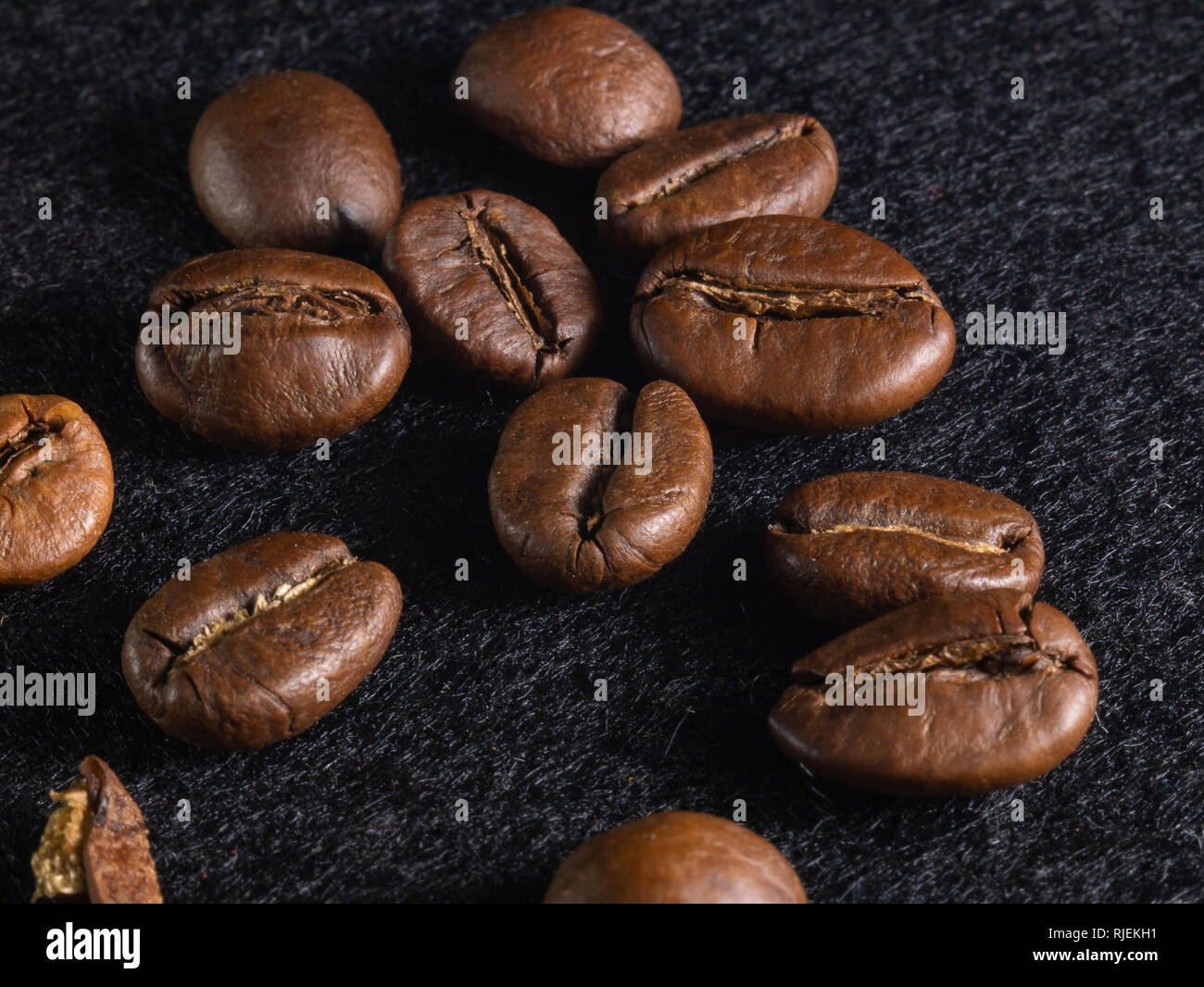 Focus on a single coffee bean on a background of many grains of coffee ...