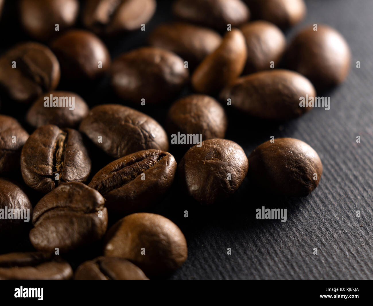 Focus on a single coffee bean on a background of many grains of coffee ...