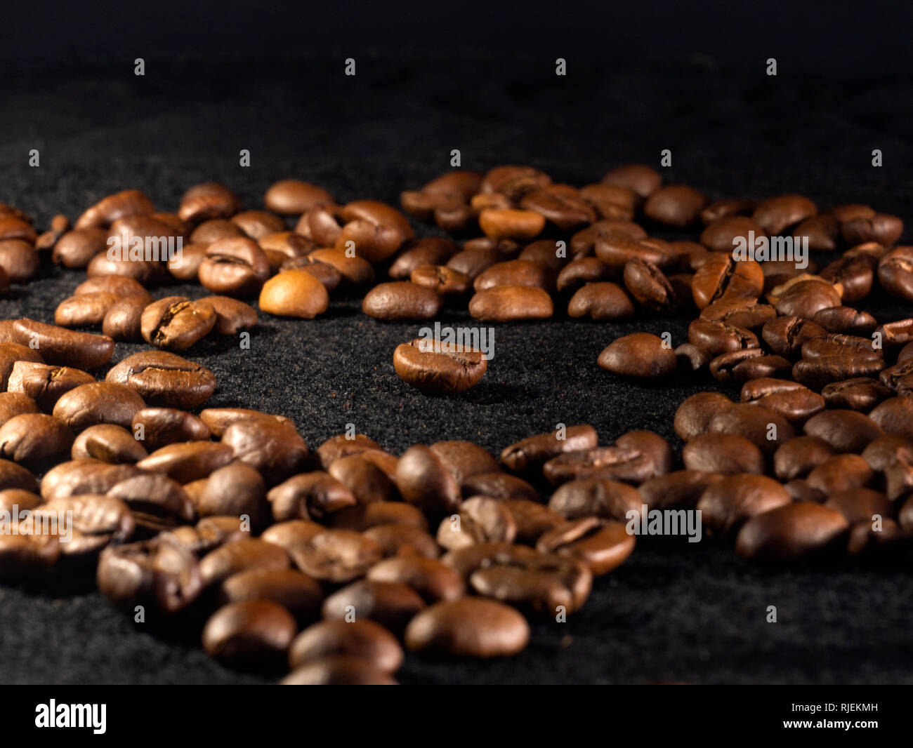 Focus on a single coffee bean on a background of many grains of coffee ...