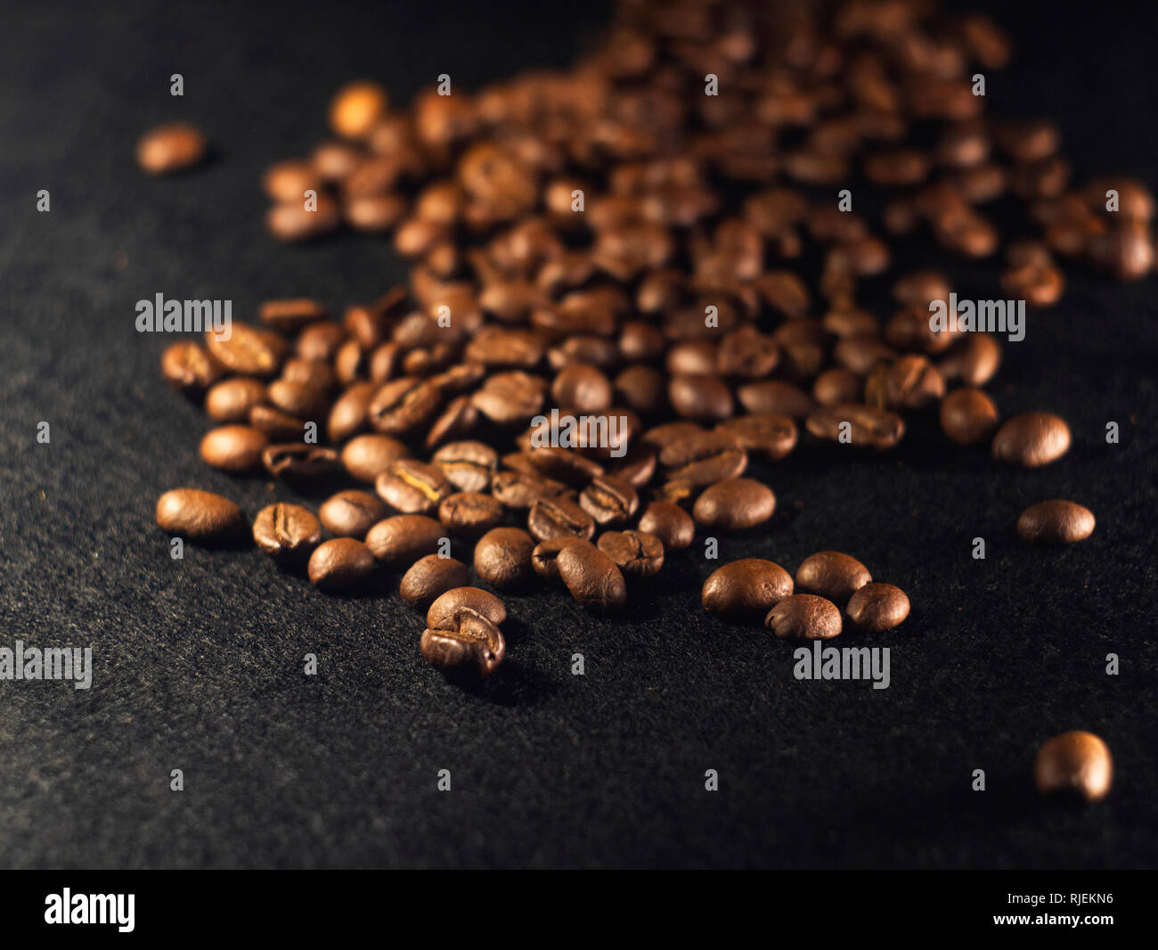 Focus on a single coffee bean on a background of many grains of coffee ...