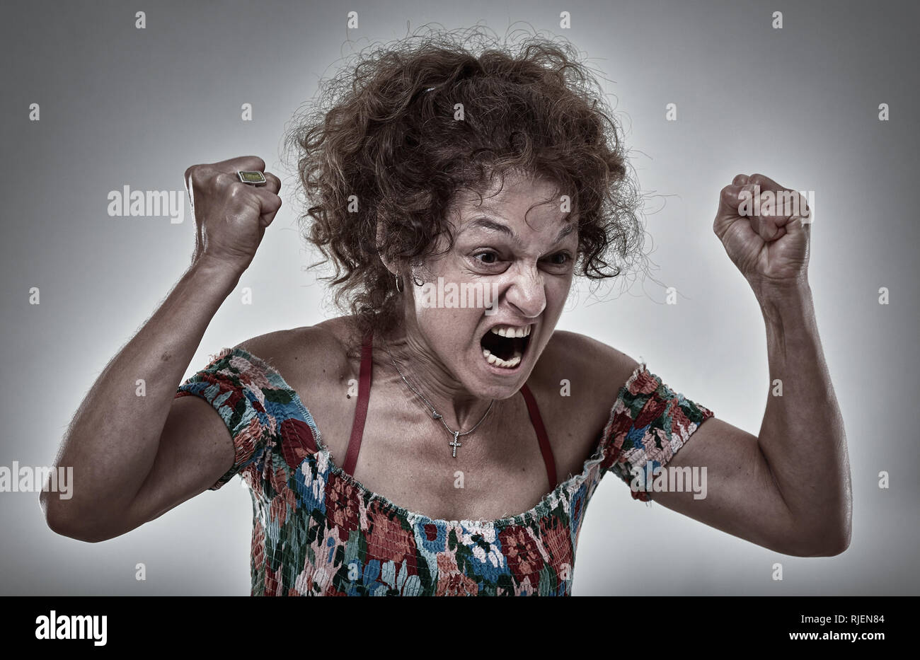 Angry senior woman yelling and raising her fists Stock Photo - Alamy