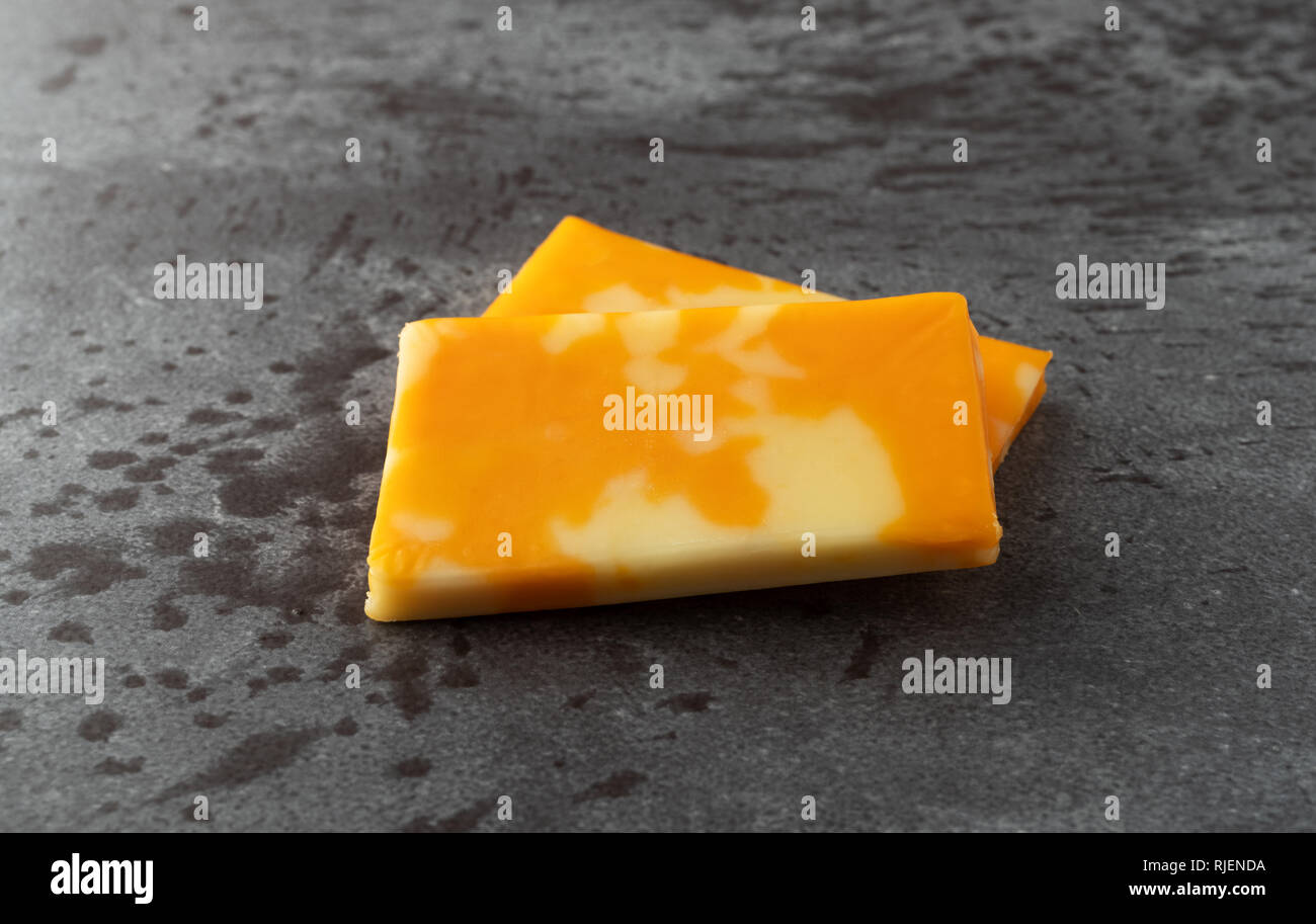 Side view of a two Colby Jack cheese bars on a gray background Stock ...