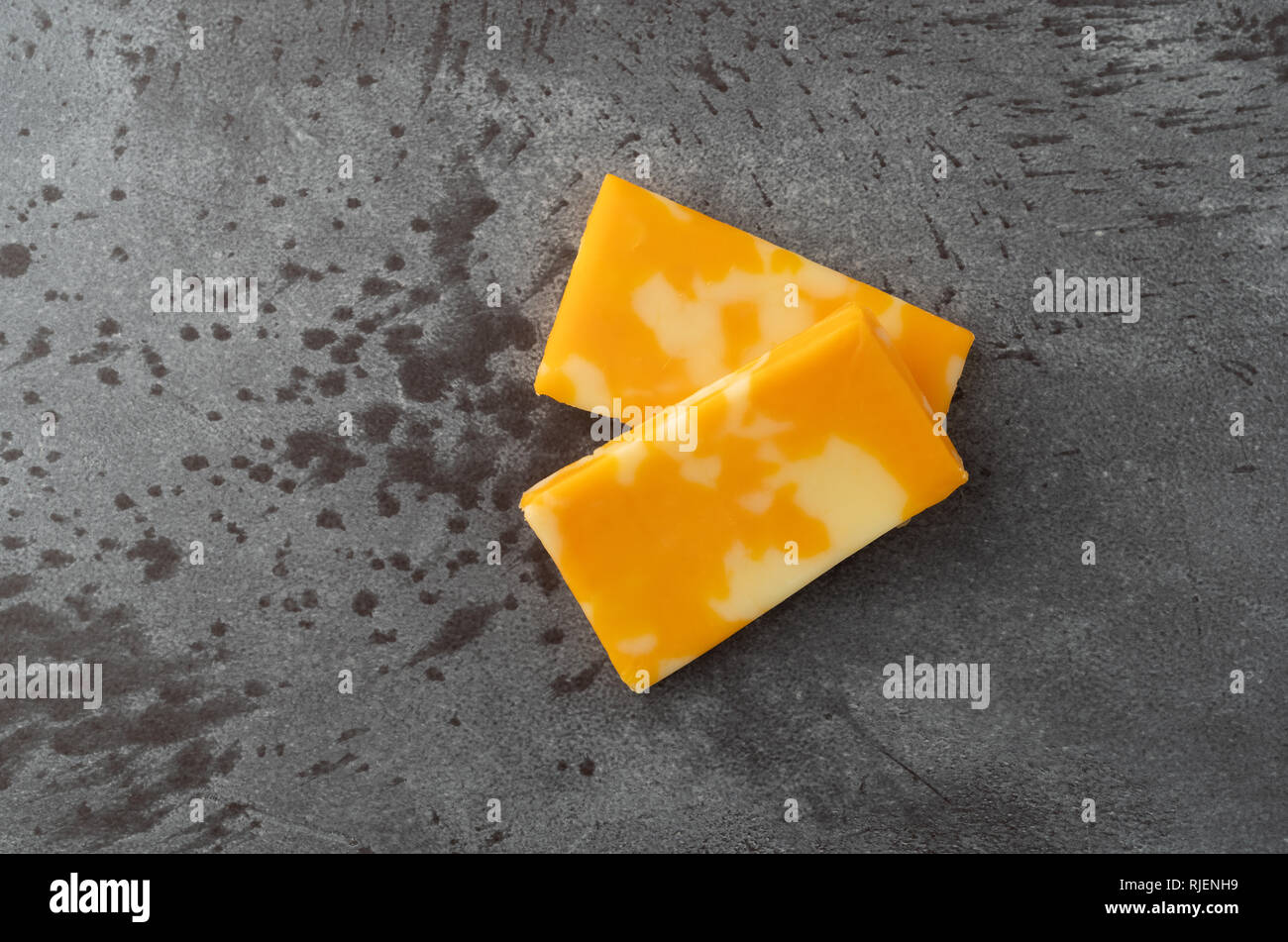 Overhead view of a two Colby Jack cheese bars on a gray background ...