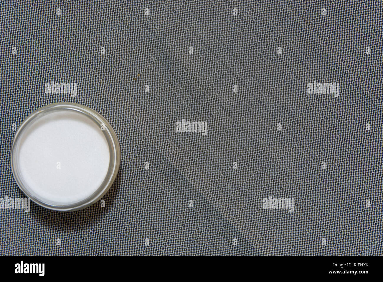 A jar of salt with grey texture background Stock Photo - Alamy