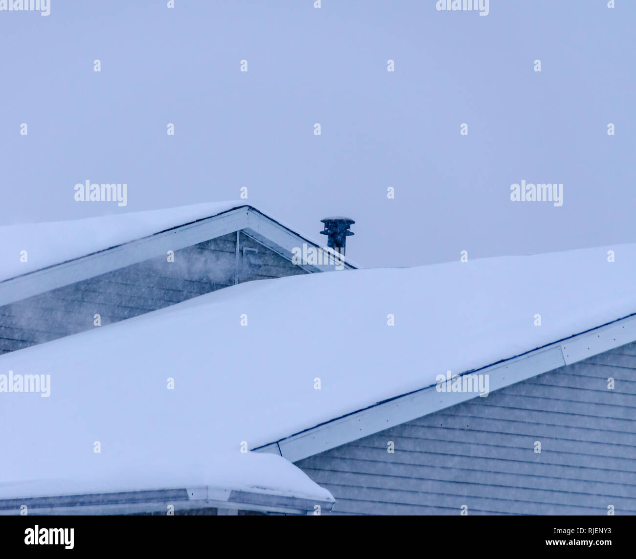 Heavy snowfall! Rooftops covered in a thick layer of snow during an ...