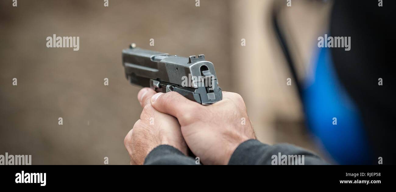 Side profile man holding gun hi-res stock photography and images - Alamy