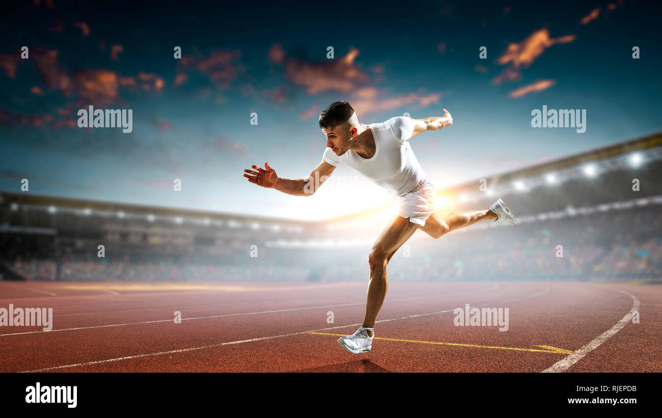 Athlete man running on racetrack at stadium mixed media hi-res stock ...